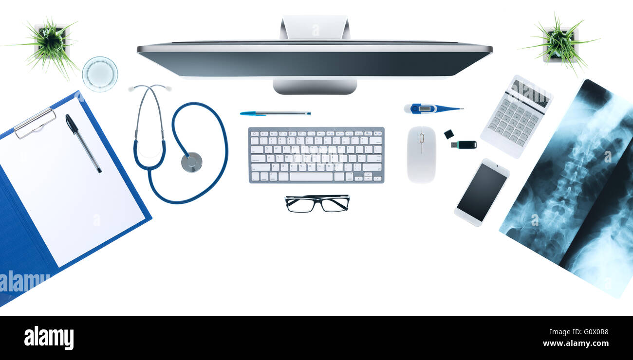 Doctor's desktop with medical equipment, computer and X-ray of human ...