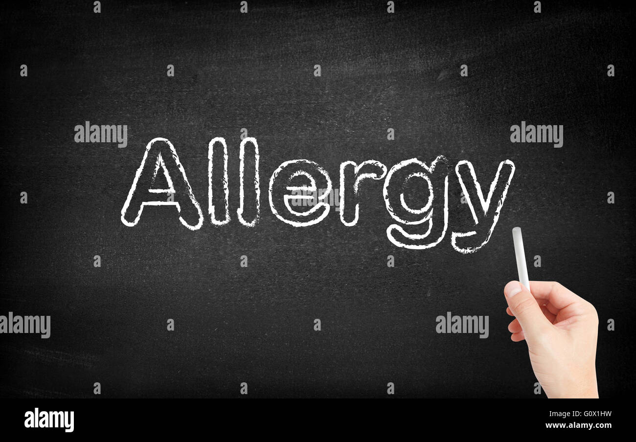 Allergy written on white blackboard Stock Photo - Alamy