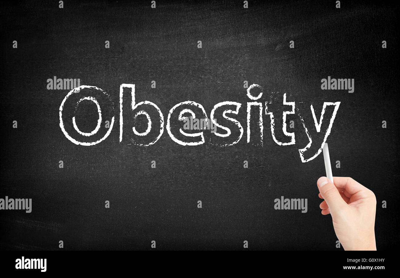 Obesity written on white blackboard Stock Photo - Alamy