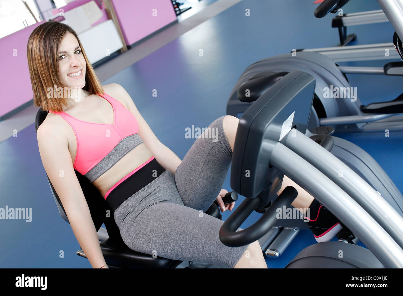 young girl doing legs exercise at gym Stock Photo - Alamy