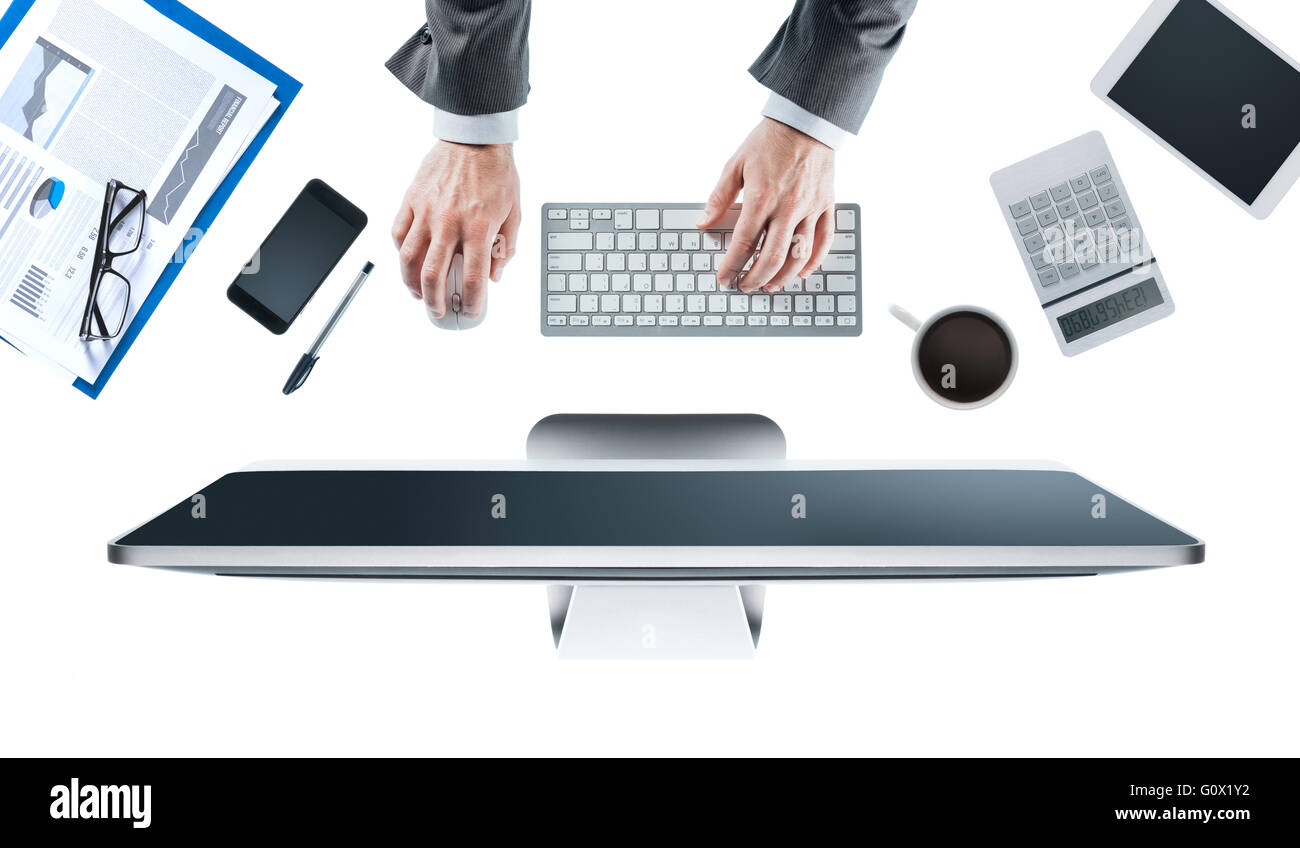 Executive businessman working on his computer at office desk, white ...