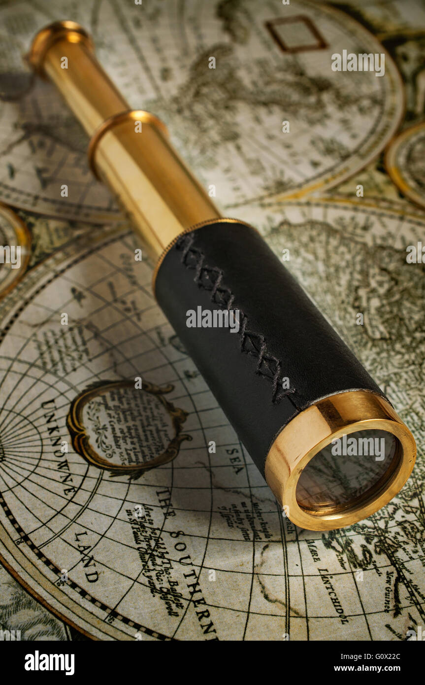 Ancient brass telescope and old map close-up Stock Photo - Alamy