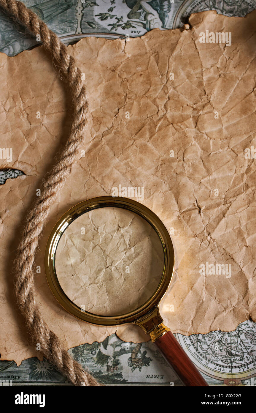 Brass magnifying glass lies on an old paper or parchment Stock Photo ...