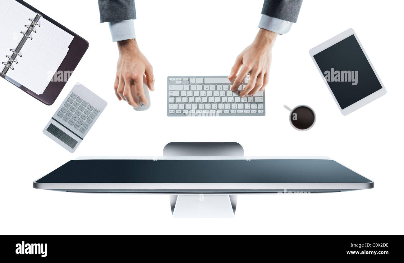 Executive businessman working on his computer at office desk, white ...