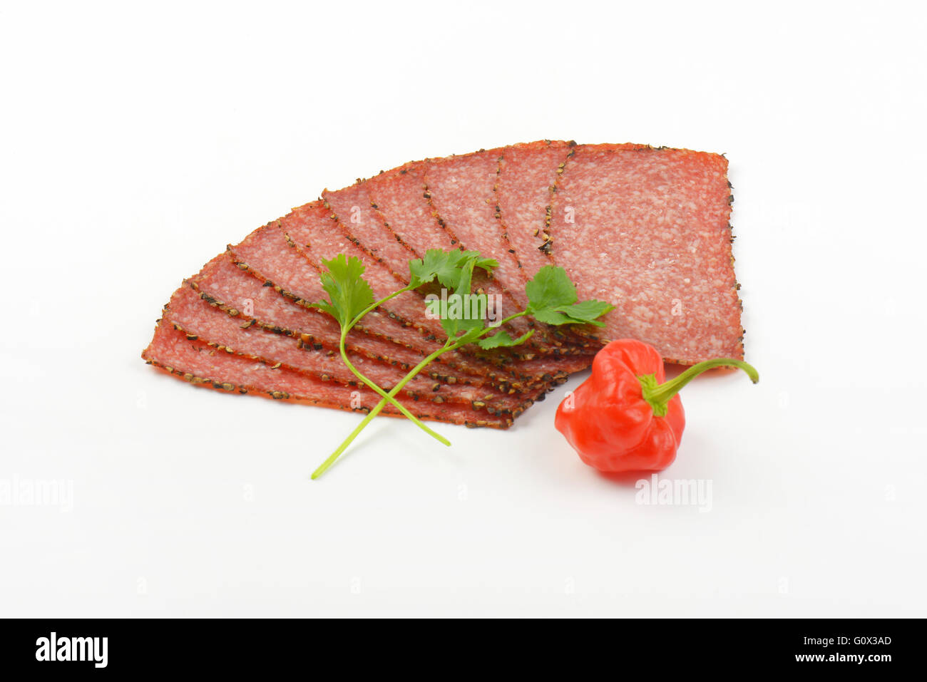 slices of pepperoni salami and spice on white background Stock Photo ...