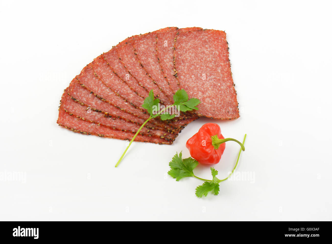slices of pepperoni salami and spice on white background Stock Photo ...