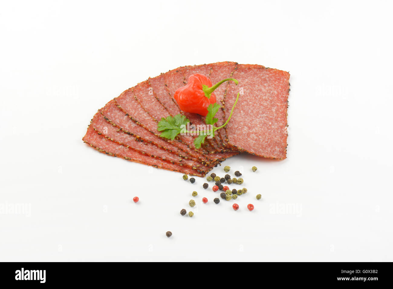 slices of pepperoni salami and spice on white background Stock Photo ...