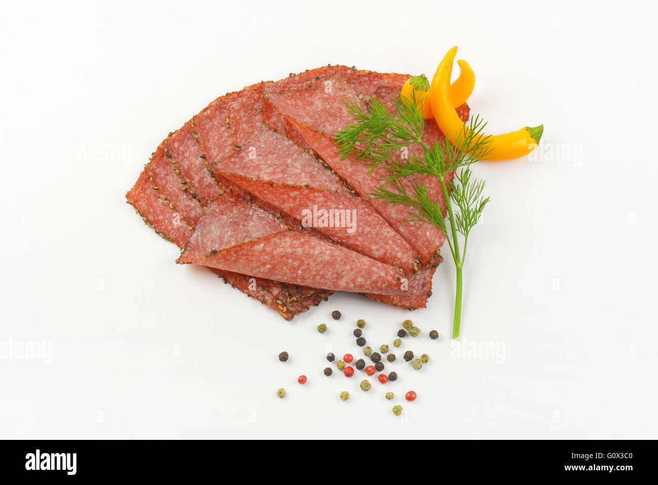 slices of pepperoni salami and spice on white background Stock Photo ...