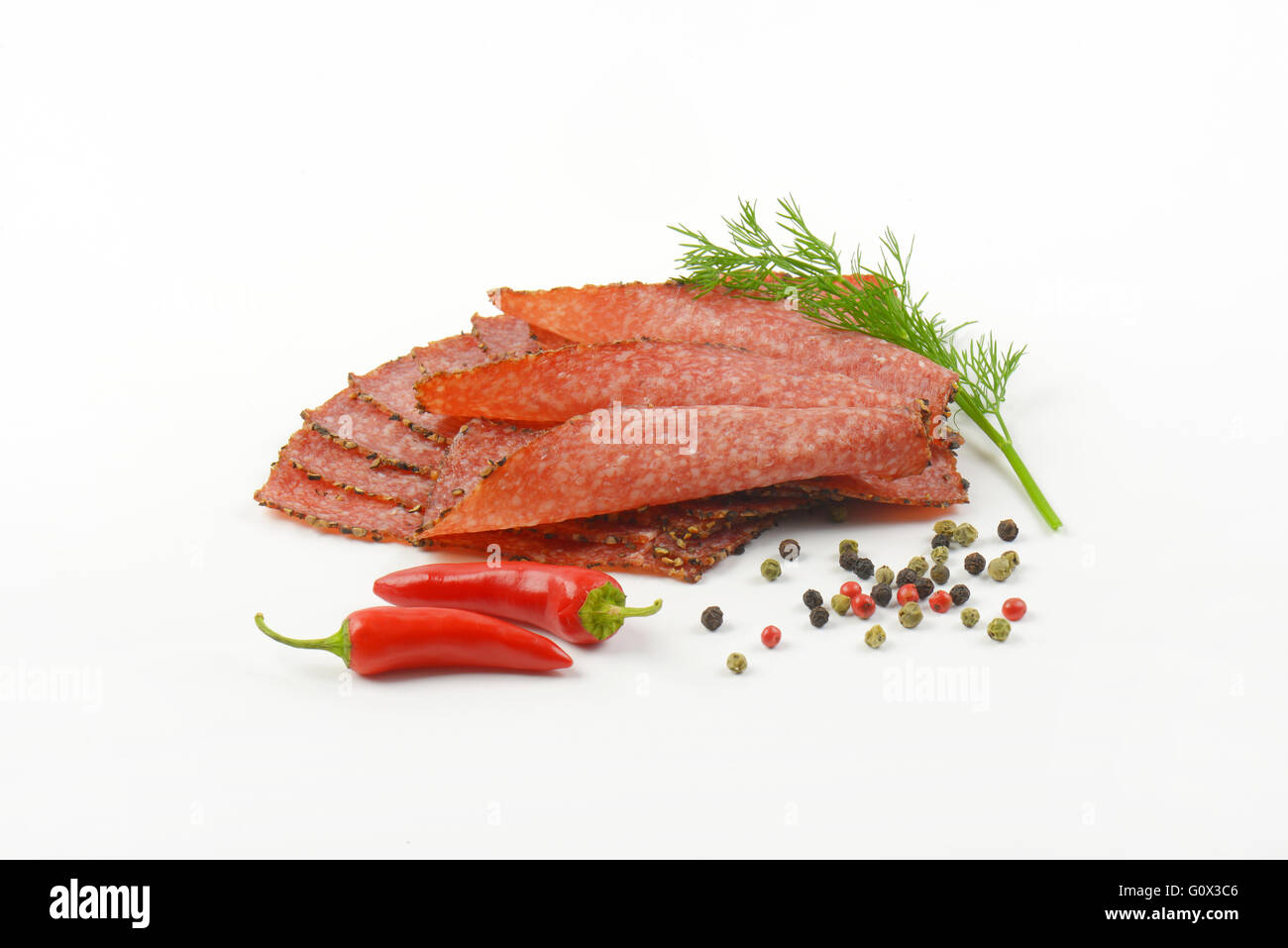 slices of pepperoni salami and spice on white background Stock Photo ...