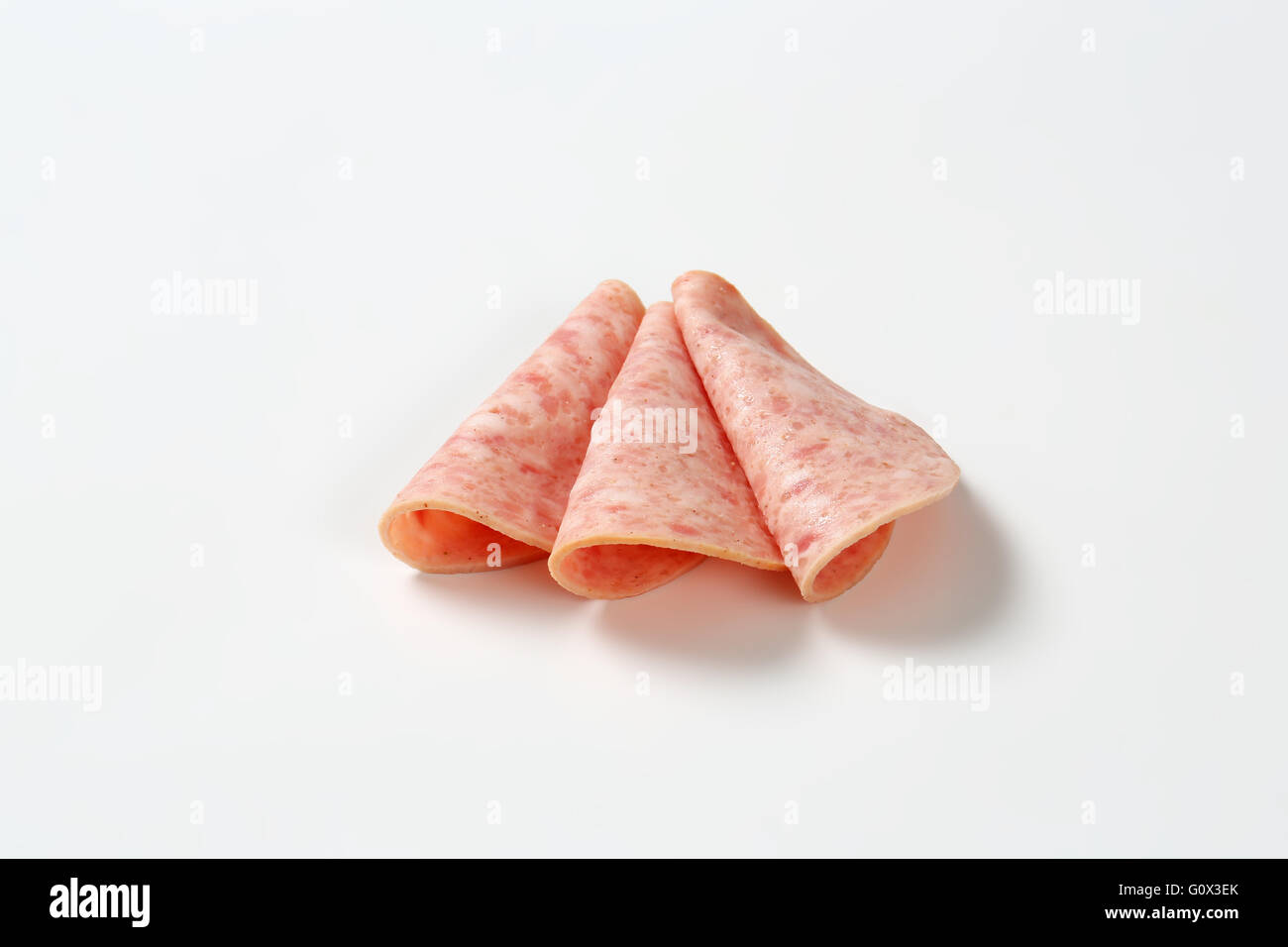 slices of ham salami arranged on white background Stock Photo - Alamy