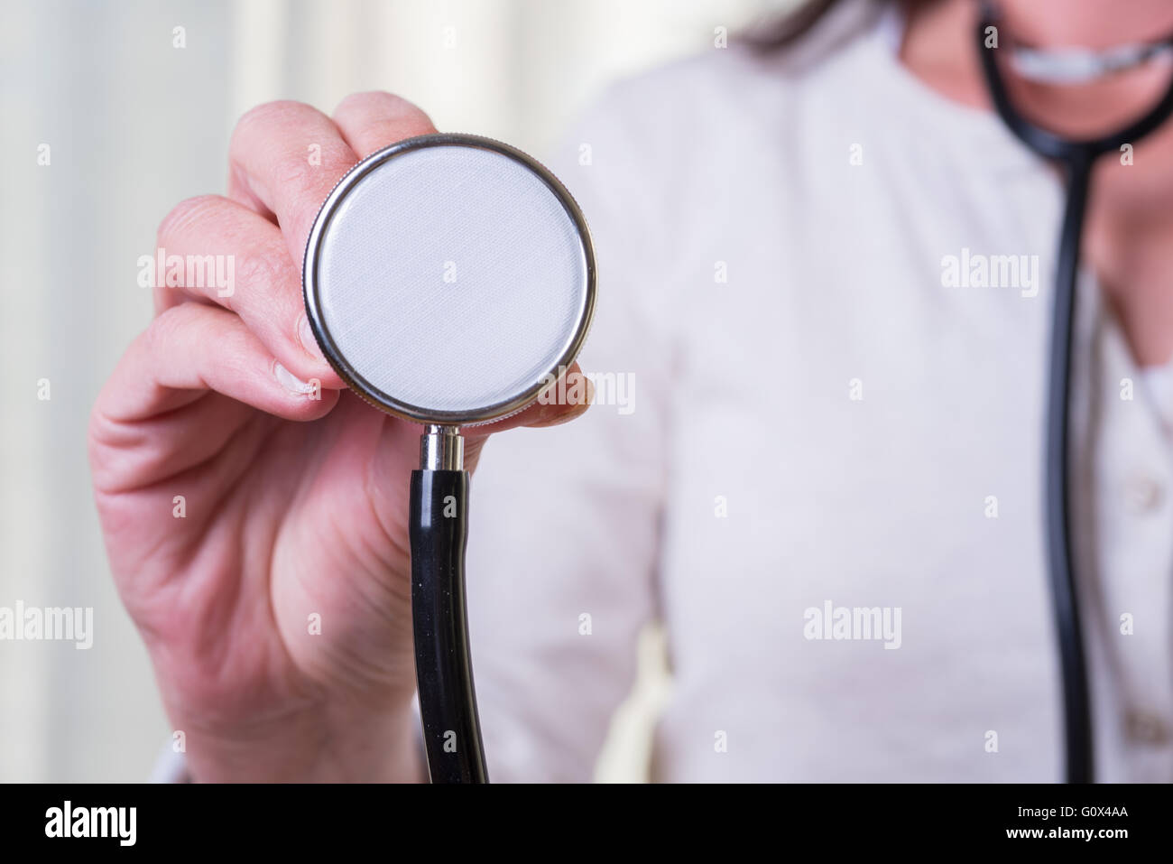 female doctor is holding stethoscope into the camera Stock Photo - Alamy