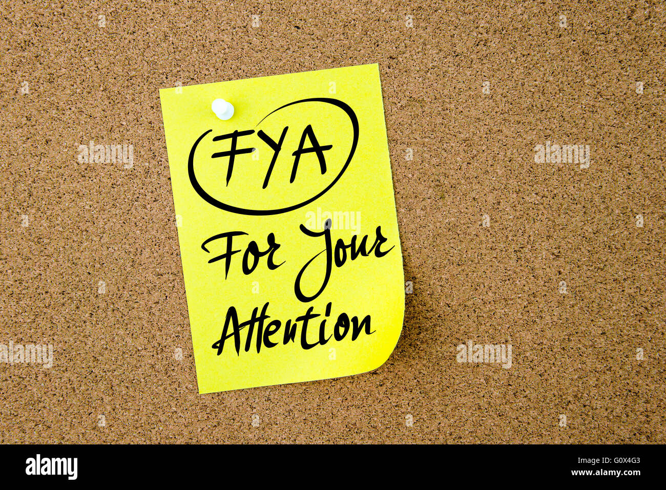 Business Acronym FYA For Your Attention written on yellow paper note ...