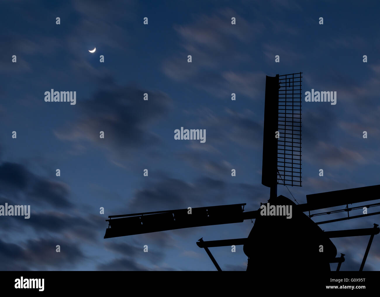 Moon out as dawn break the night sky at Foxton windmill Stock Photo - Alamy