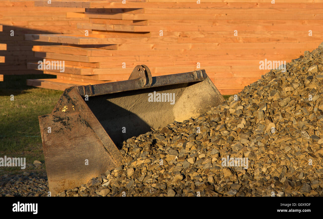 Digger bucket in a pile of gravel at a construction site Stock Photo ...