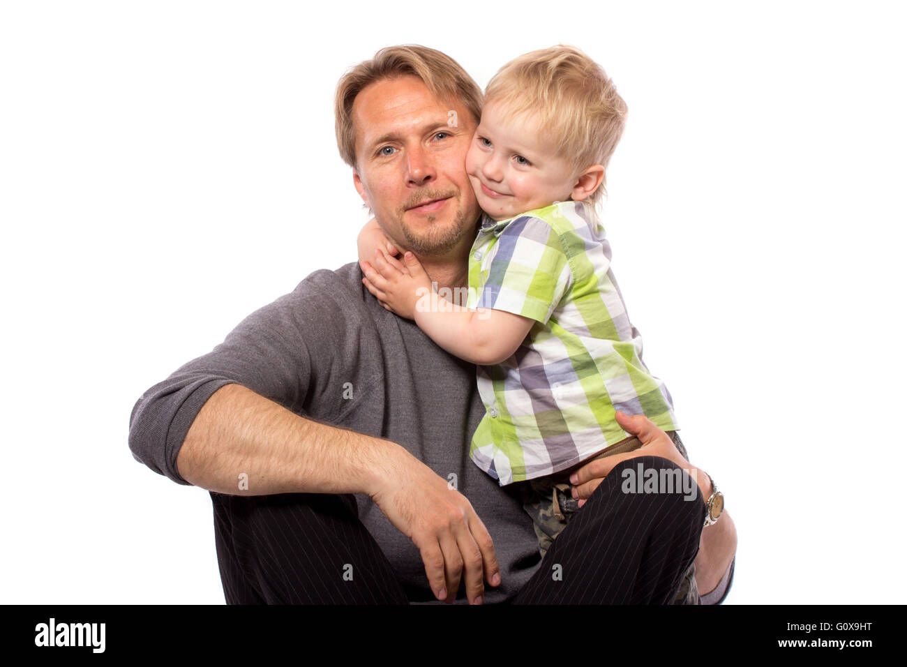 Happy family of father embracing his son smiling looking at camera ...
