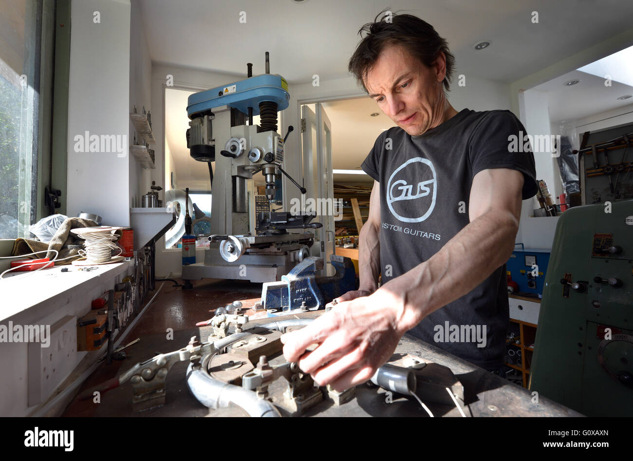 Simon Farmer, founder of Gus Custom Guitars with a guitar designed for ...