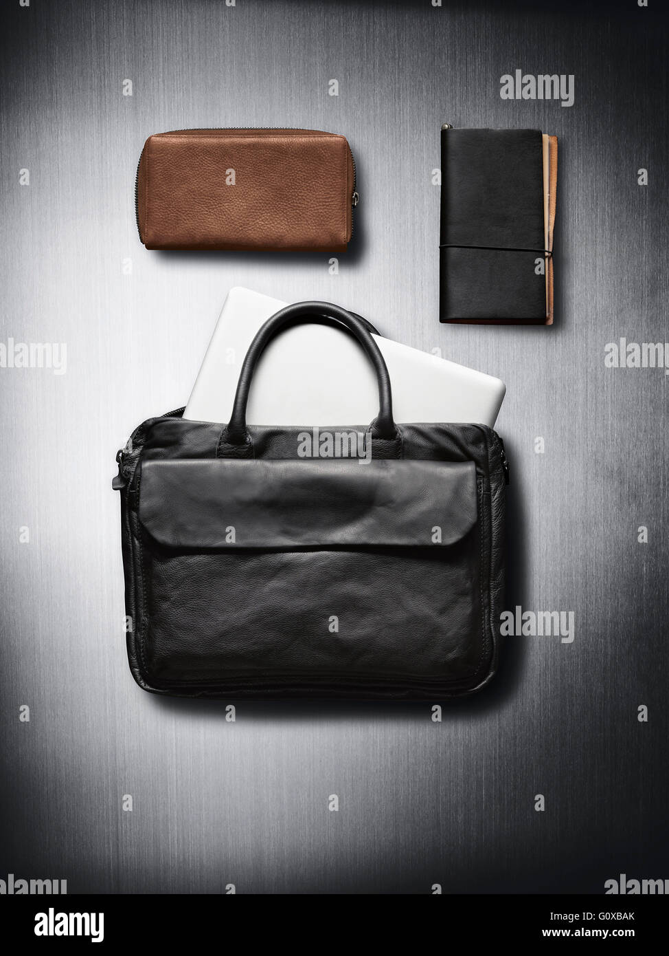 Bags and notebook on metallic background in studio Stock Photo - Alamy