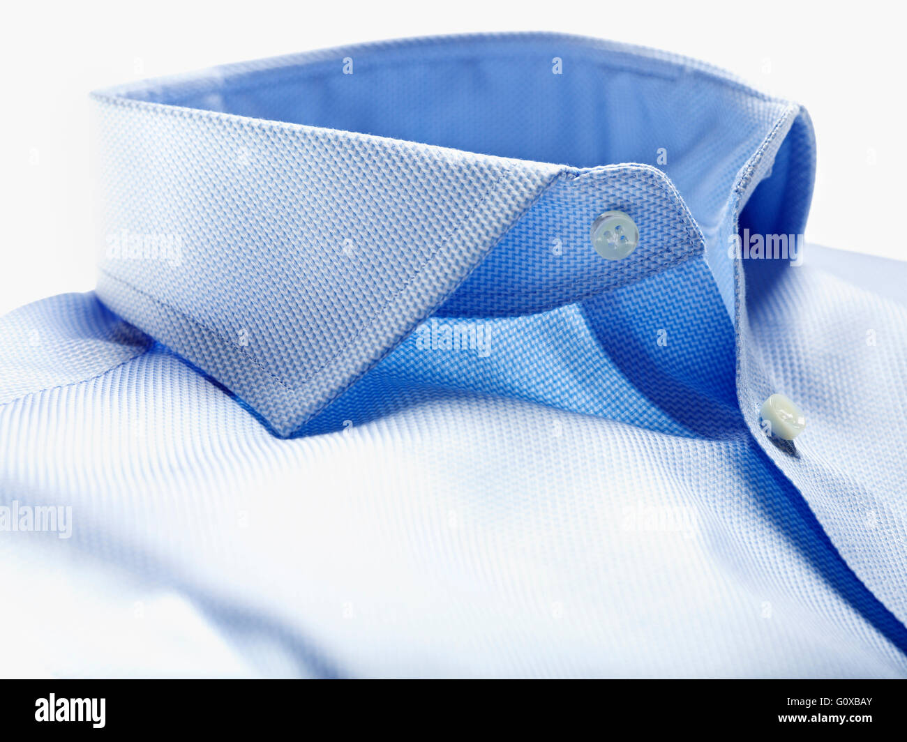 Detail of collar of blue shirt on white background in studio Stock ...