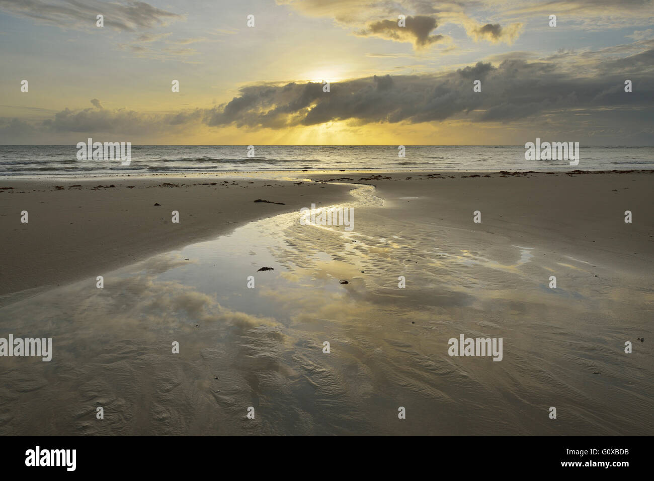 Sandy Beach with Tideway Watercourse and Storm Clouds at Sunrise ...