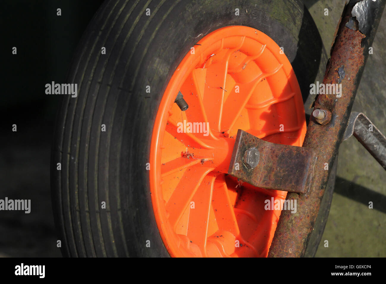 Wheel of upturned wheelbarrow Stock Photo - Alamy