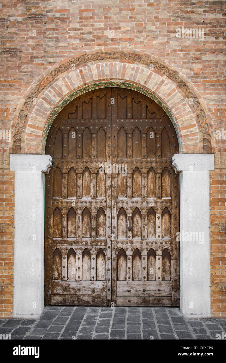 Arched entrance of a medieval palace with carved wooden door Stock ...