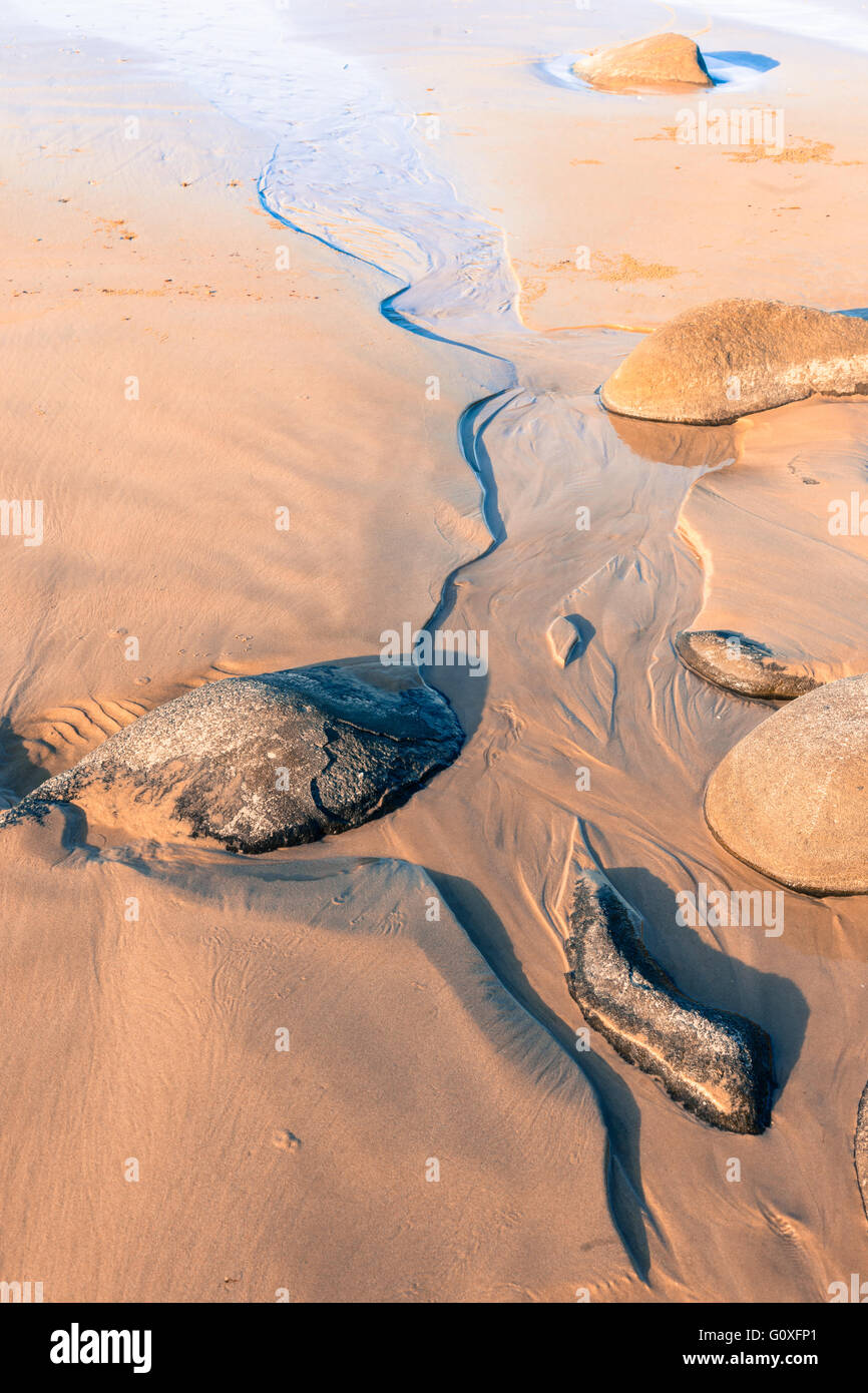 Small stream in sand running to tidal edge Stock Photo - Alamy