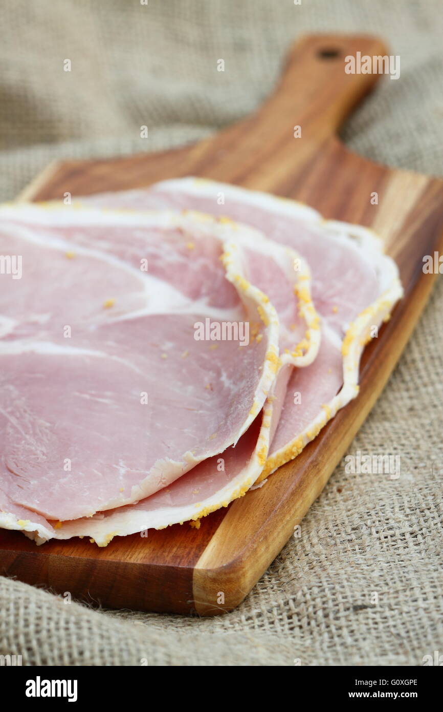 Ham slices wooden chopping board Stock Photo - Alamy