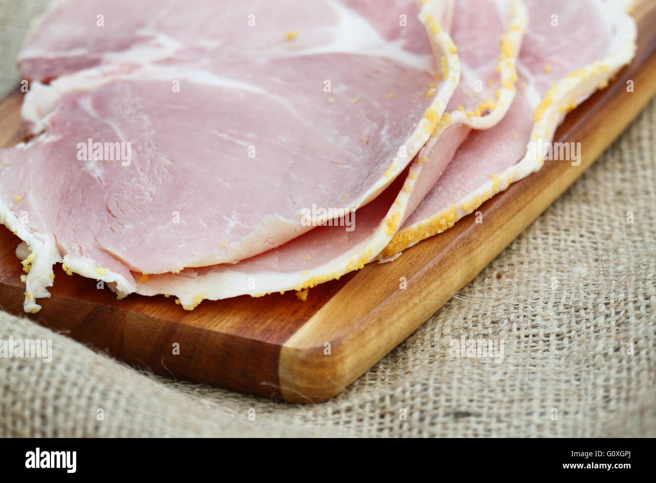 Ham slices wooden chopping board Stock Photo - Alamy