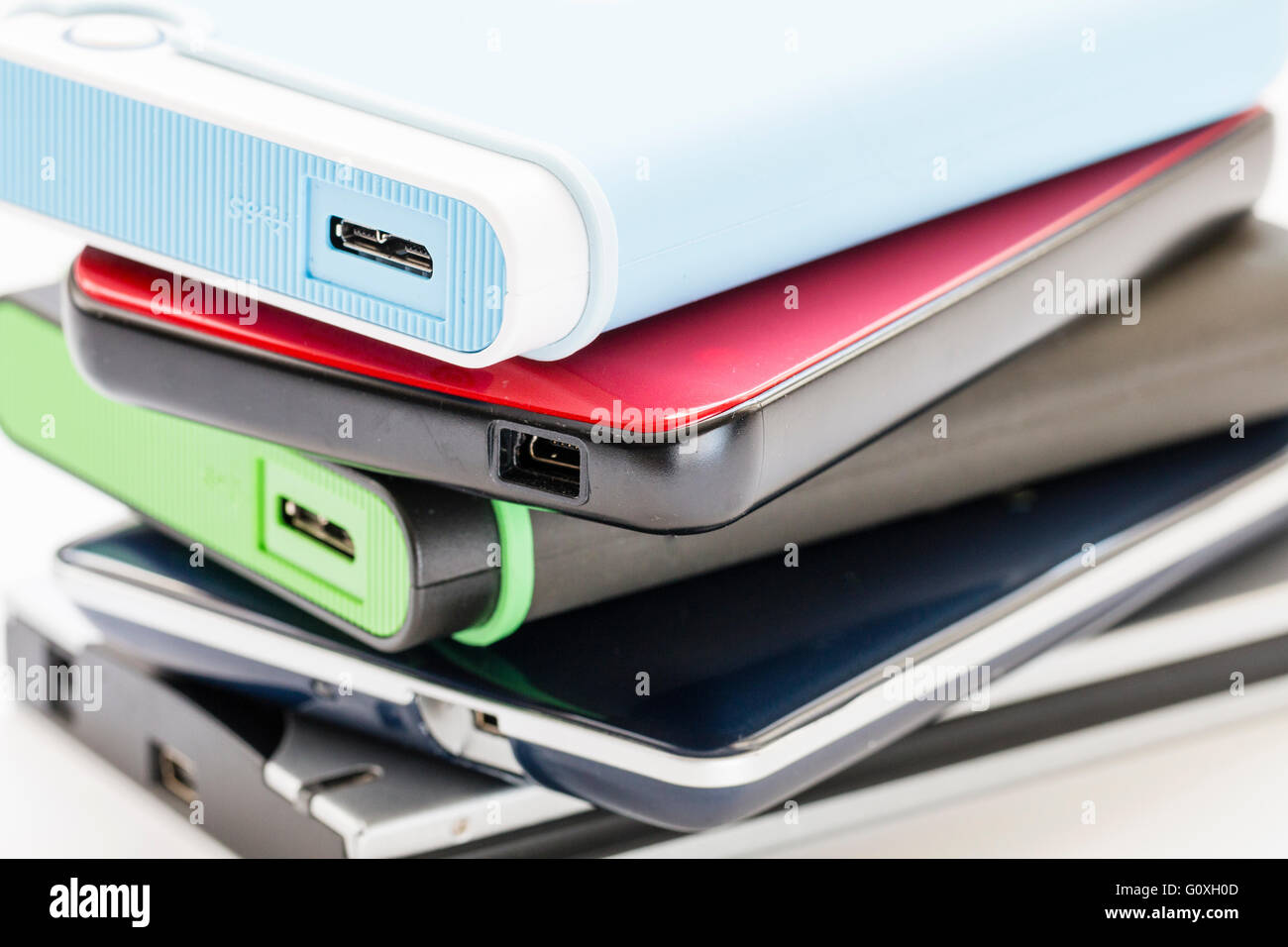 Five different and various coloured external portable hard drivers ...