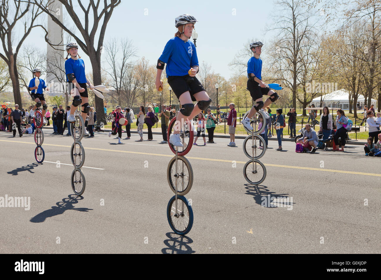 Three wheeled unicyclists at a cultural festival parade - USA Stock ...