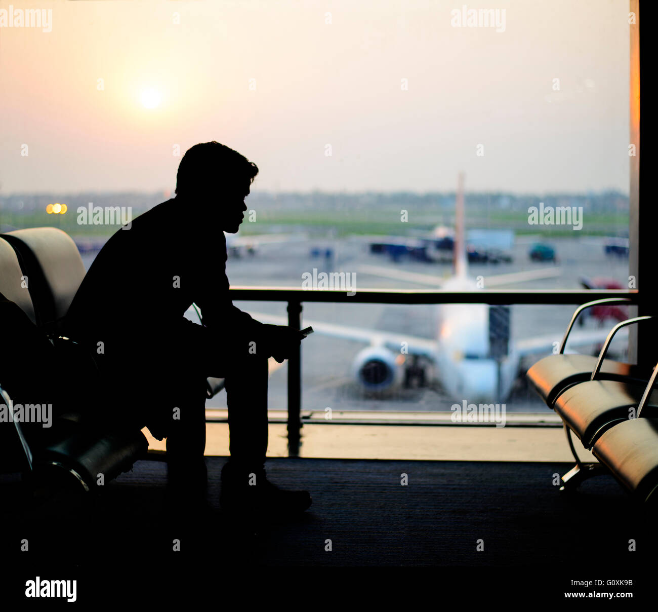 Man waiting for a flight Stock Photo - Alamy