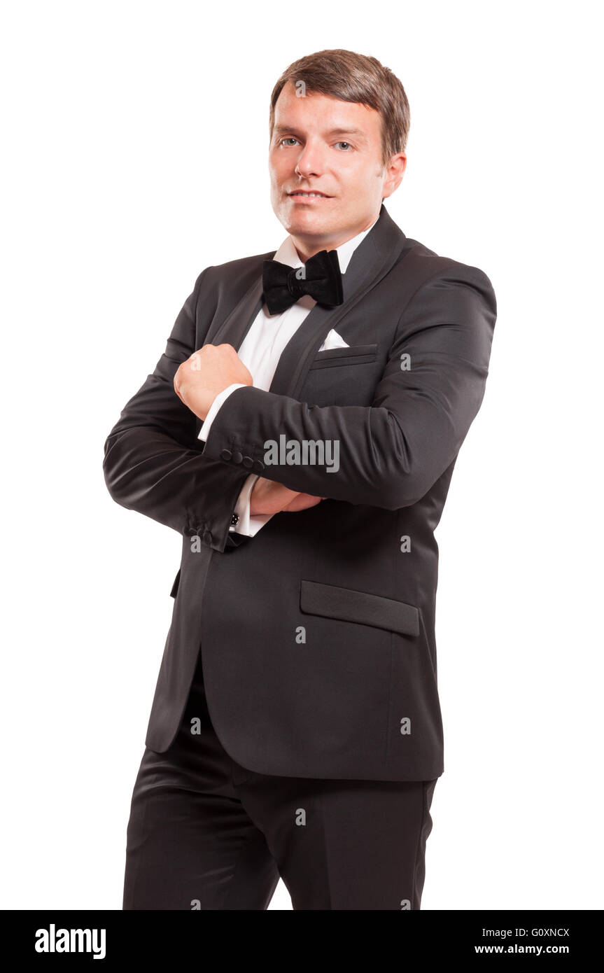 Elegant male model wearing a tuxedo and a bowtie, isolated on a white ...