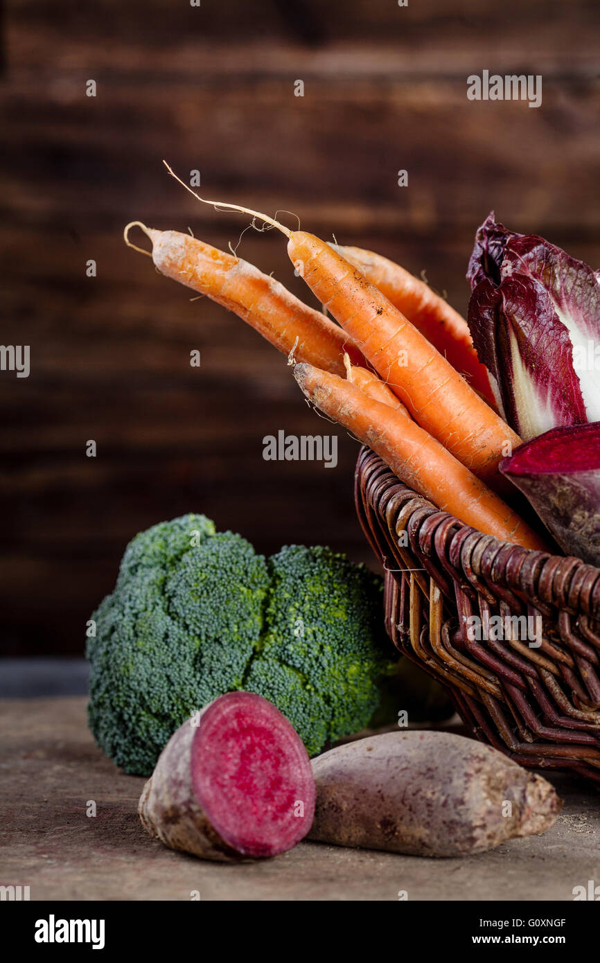 Basket full of healthy vegetables like carrots, beetroot, chicory ...