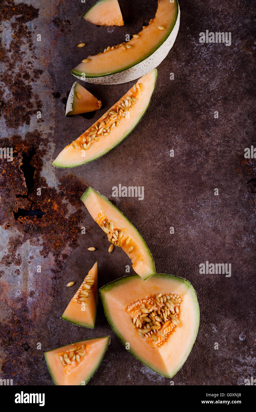 Melon slices in rusty metal background from the top Stock Photo - Alamy