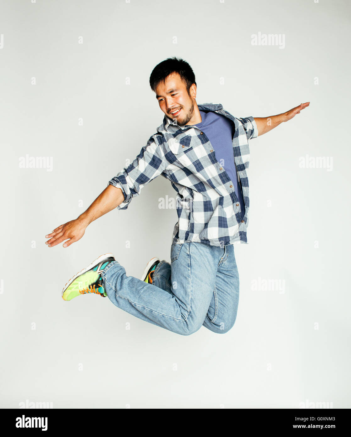 young pretty asian man jumping cheerful against white background ...