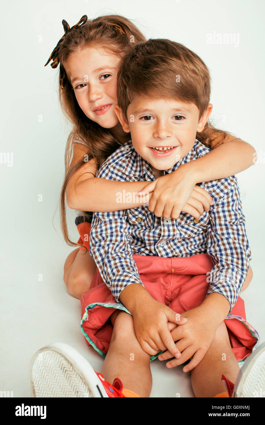 little cute boy and girl hugging playing on white background, happy family Stock Photo - Alamy