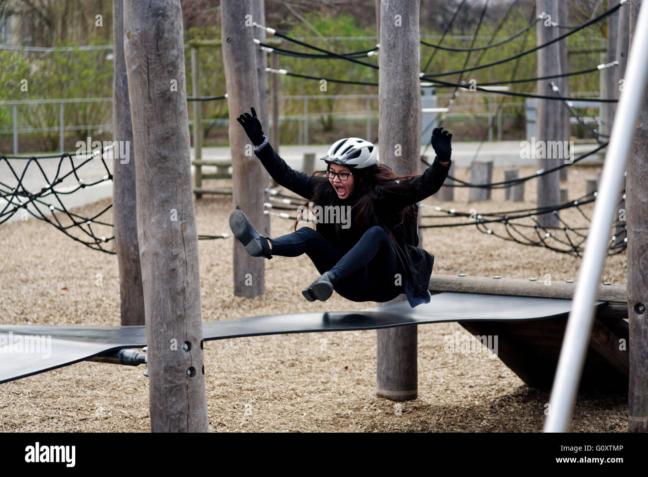 A girl being flung into the air on a trampoline Stock Photo - Alamy