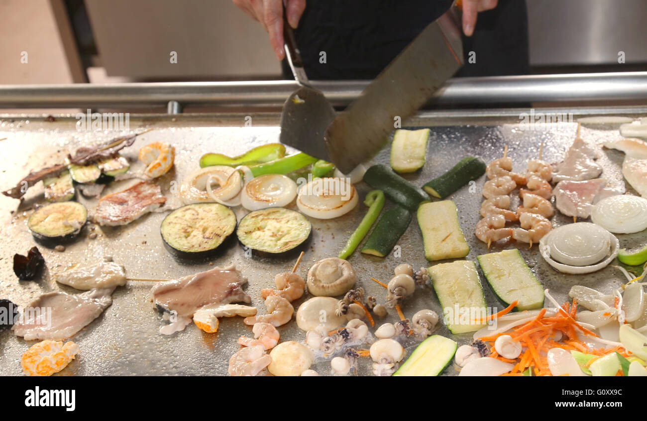 chef while cooking food in the kitchen of the chinese restaurant Stock ...