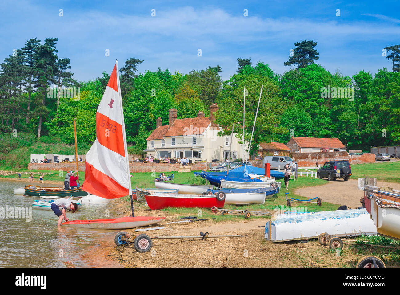 Sailing England river, view of small sailing boats drawn up along the ...
