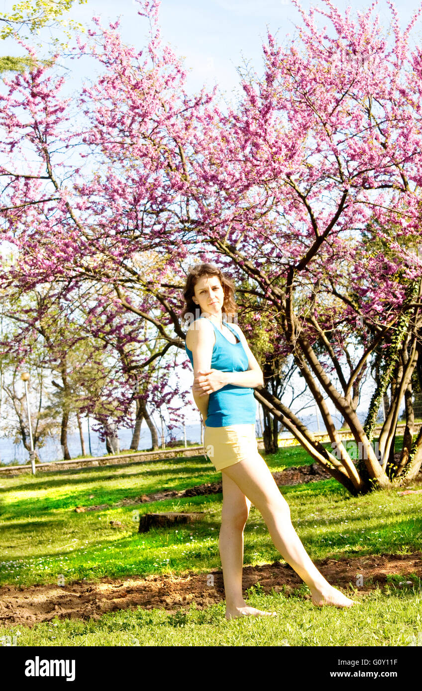 Woman stands near tree walking hi-res stock photography and images - Alamy