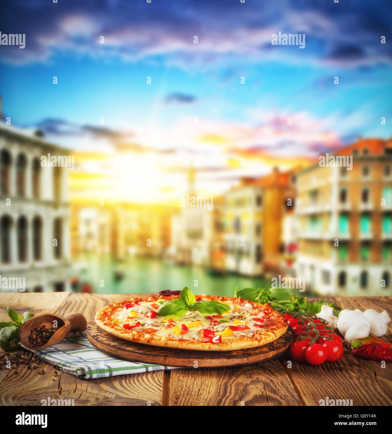 Rustic pizza with mozzarella, olives, basil and ham served on vintage ...