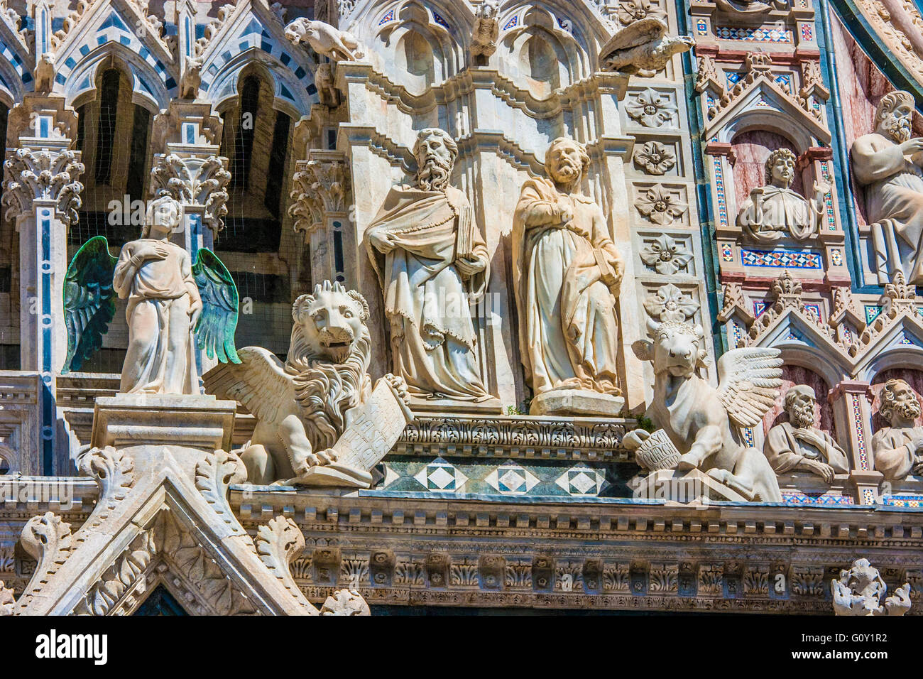 Main facade of Siena Cathedral. Detail with Statues of Saints angel and ...