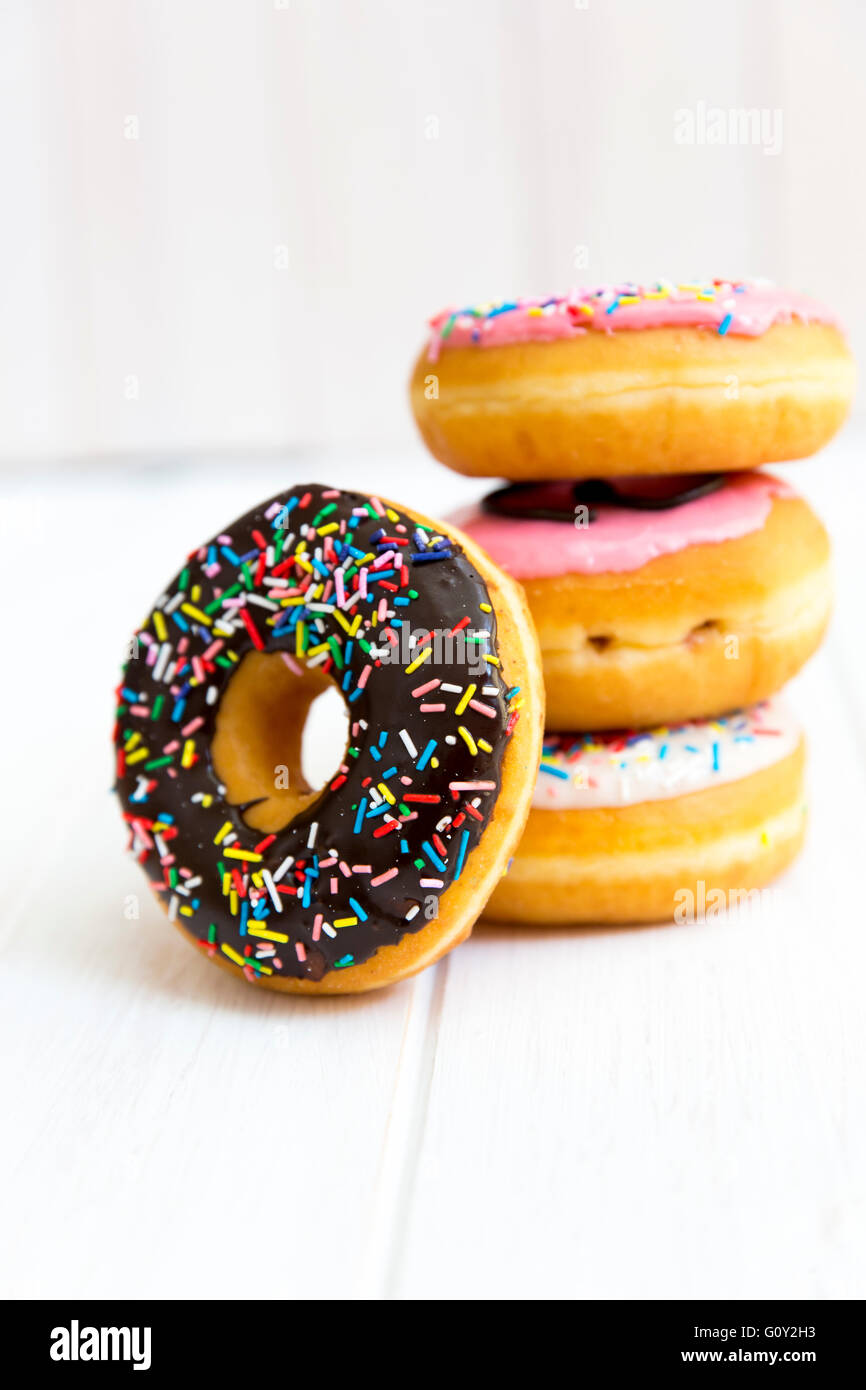 Stack of multi coloured donuts with icing Stock Photo - Alamy