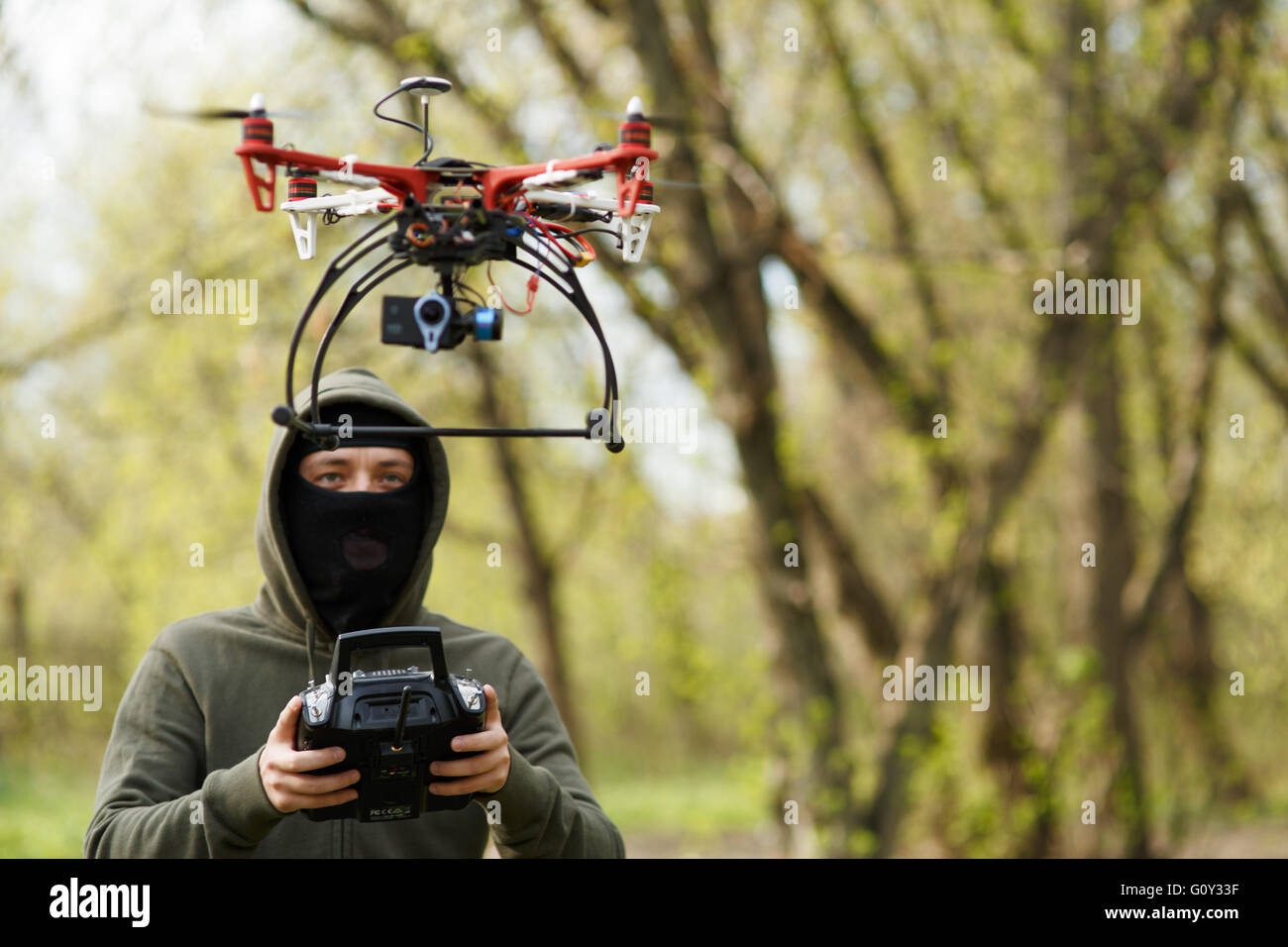 Man in mask operating a drone with remote control. Crime concept Stock ...