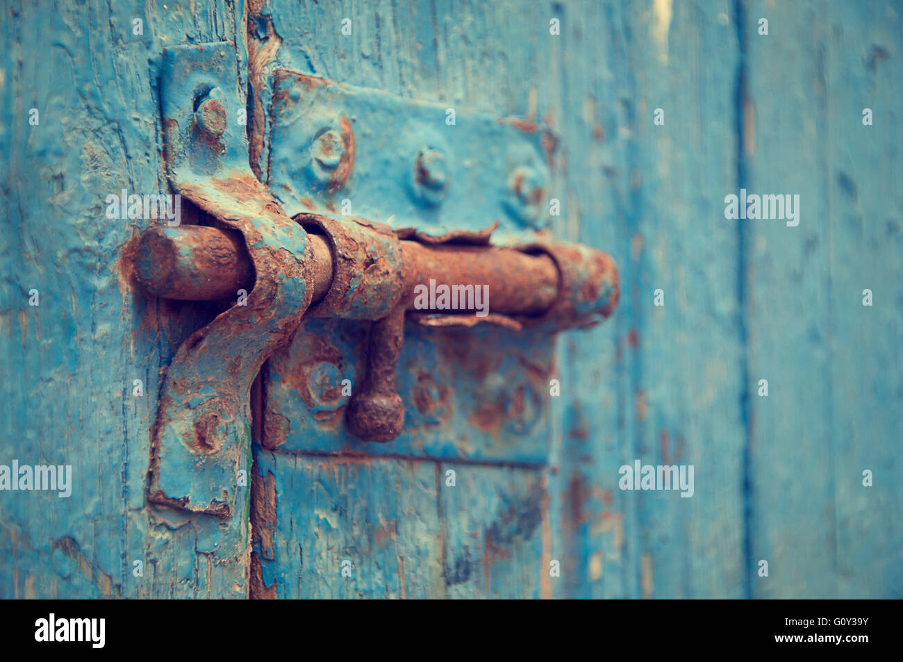 Rusty bolt on blue wooden door Stock Photo - Alamy