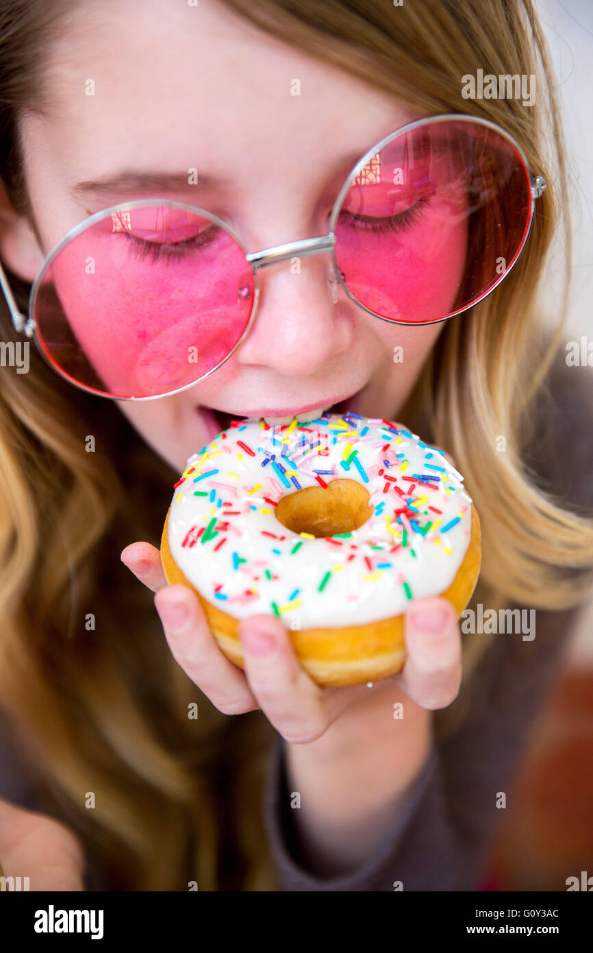 Girl eating a donut hi-res stock photography and images - Alamy