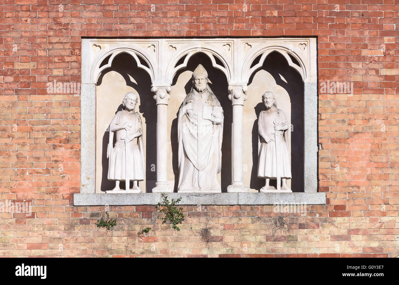 In the picture three statues, located in the center the statue of Saint ...