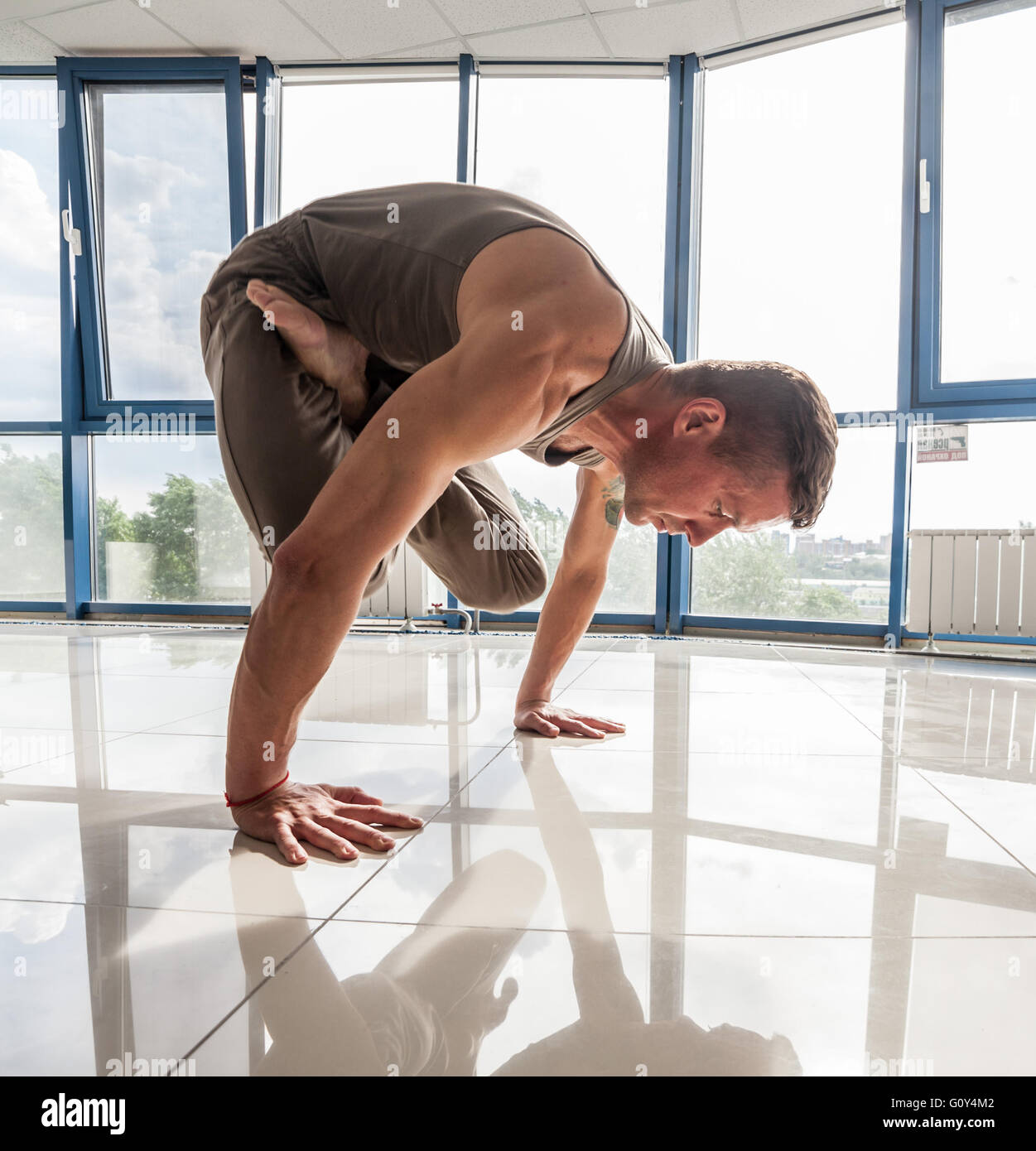 Athletic muscular young man working out, yoga Stock Photo - Alamy