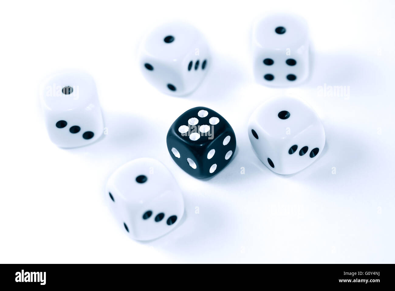 One black dice among few white dices on white background Stock Photo ...