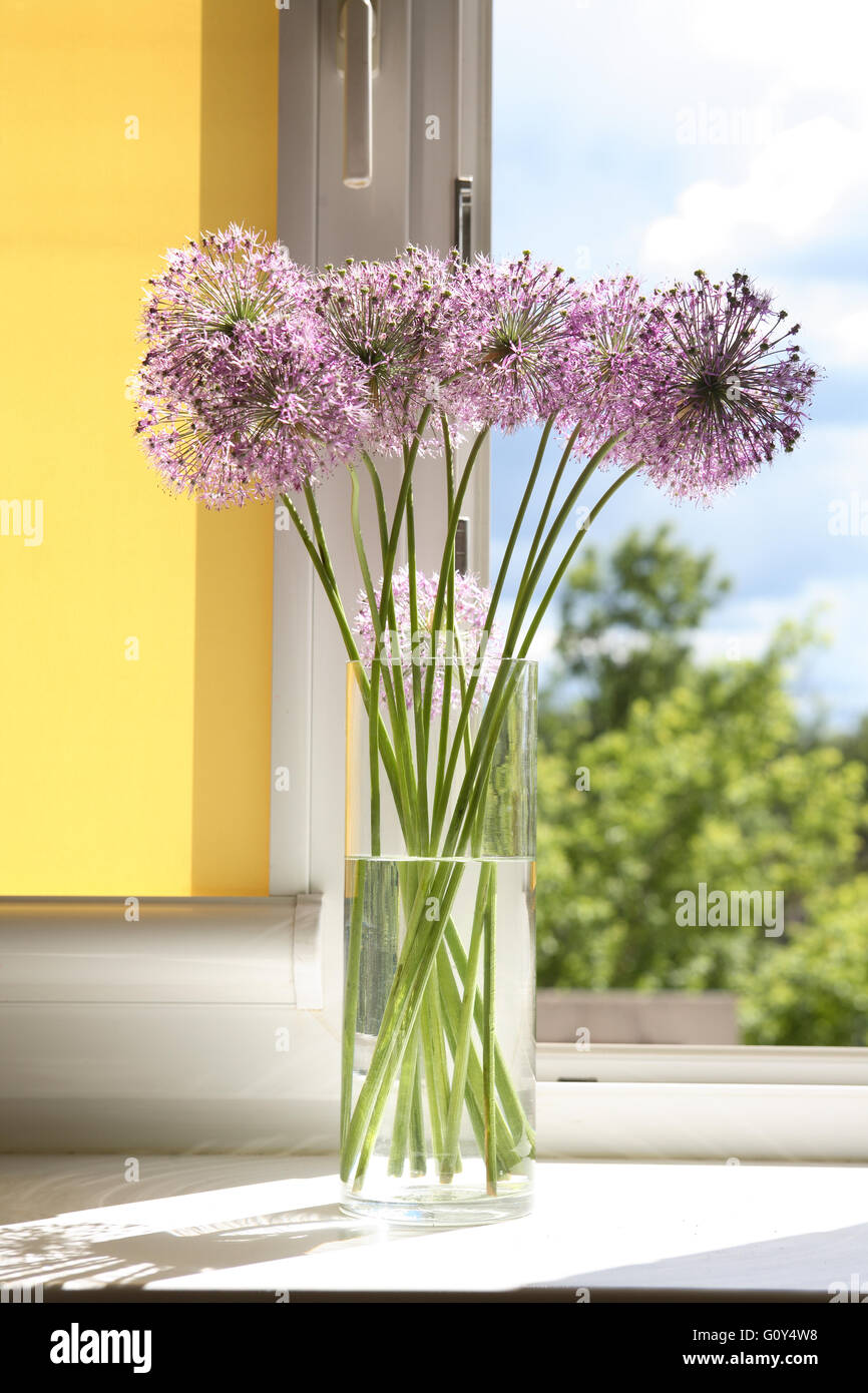 Nice bouquet of flowers in glass vase on window-sill Stock Photo - Alamy